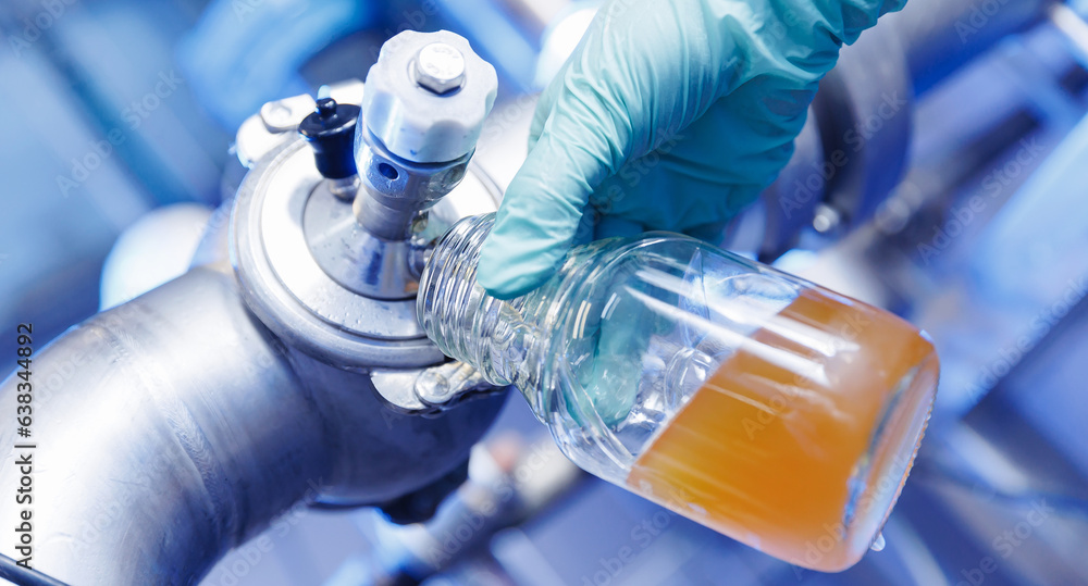 Laboratory assistant inspecting production beer, analysis drink in ...