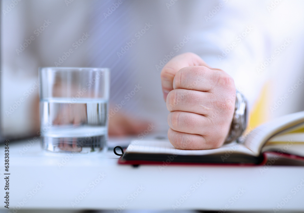 Male clenched fist in suit at office closeup. Aggressive career ...