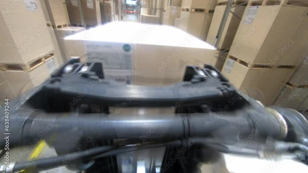 Logistics center forklift transporting pallets in warehouse pov ...
