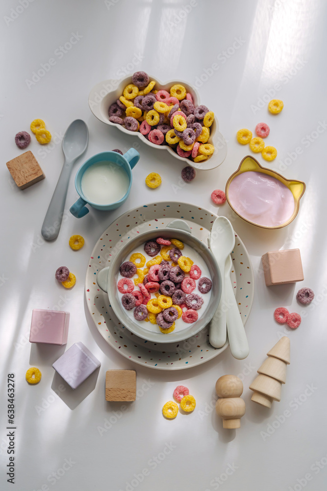 Dry children's breakfast. Cute children's plates and bowl with colorful ...