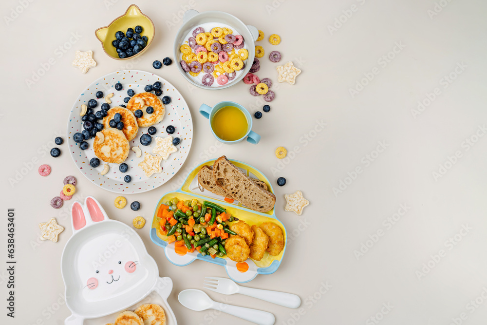 Cute plates with a variety of children's food. Vegetables, nuggets ...