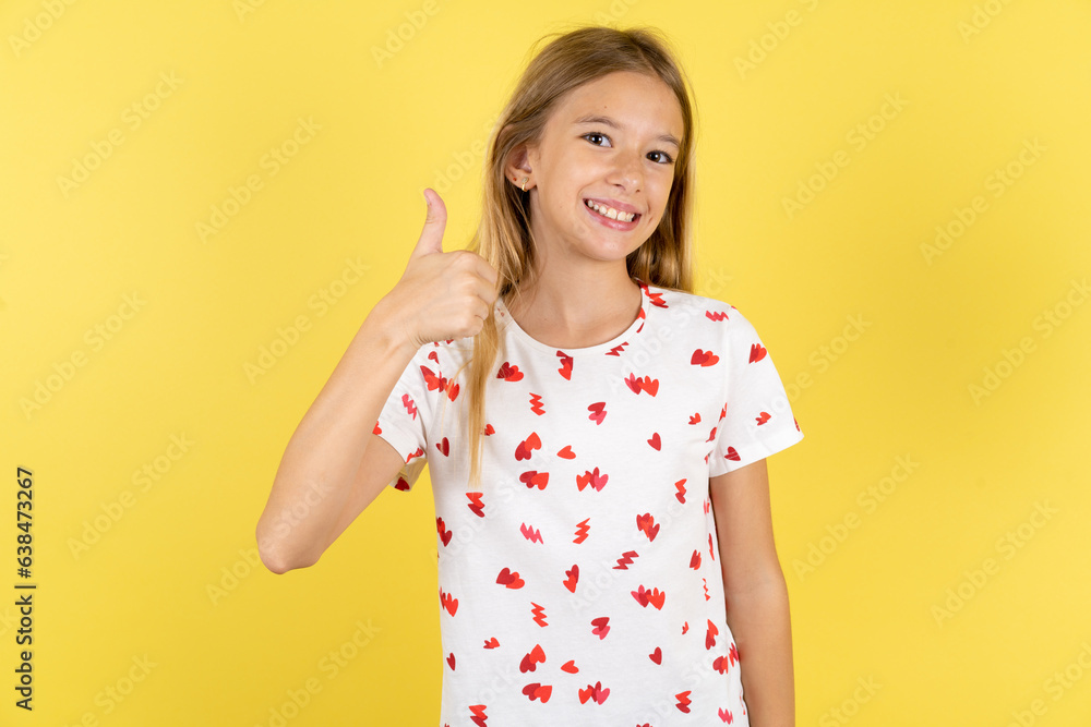Beautiful teen girl doing happy thumbs up gesture with hand. Approving ...