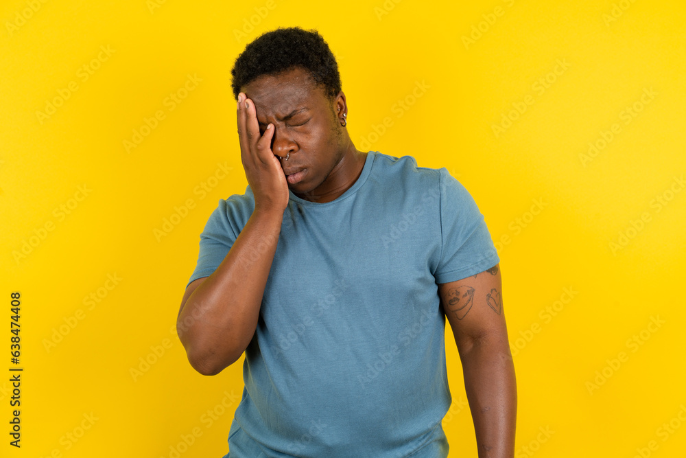 Tired overworked Young handsome man standing over yellow studio ...