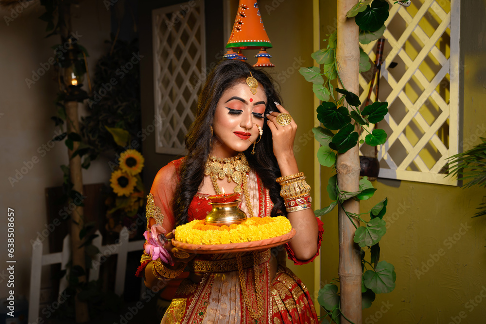 Portrait of pretty young Indian girl wearing traditional saree, gold ...