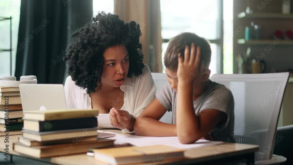 Sad primary school boy kid feeling upset while his mother screaming at ...