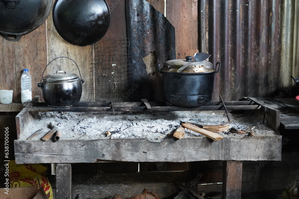 Foto de Cooking using classic pan or metal pot set on a charcoal stove ...