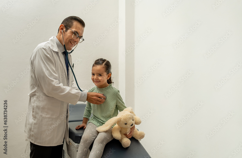 hispanic doctor listening at little girl's heartbeat. Latin ...