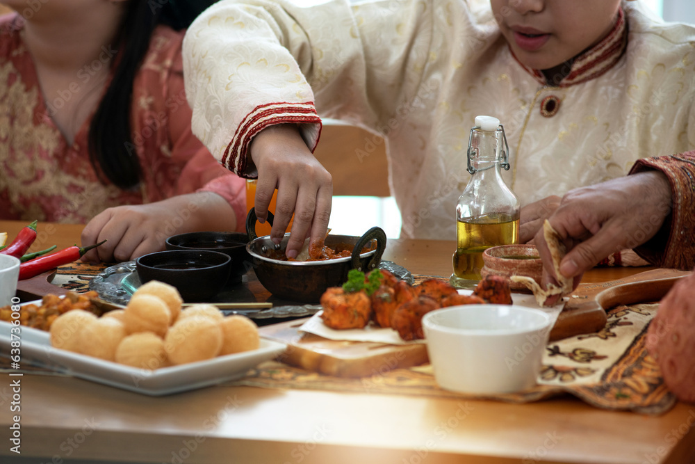 Closeup, Indian boy in traditional cloth enjoy eating with Indian ...