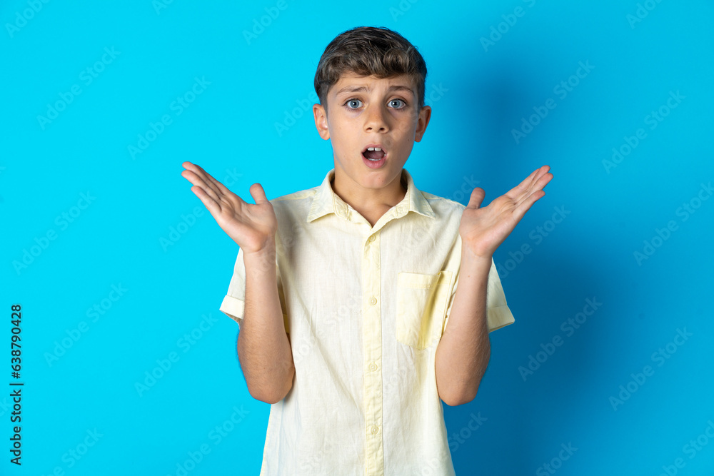 Surprised terrified Beautiful kid boy wearing casual shirt Gestures ...