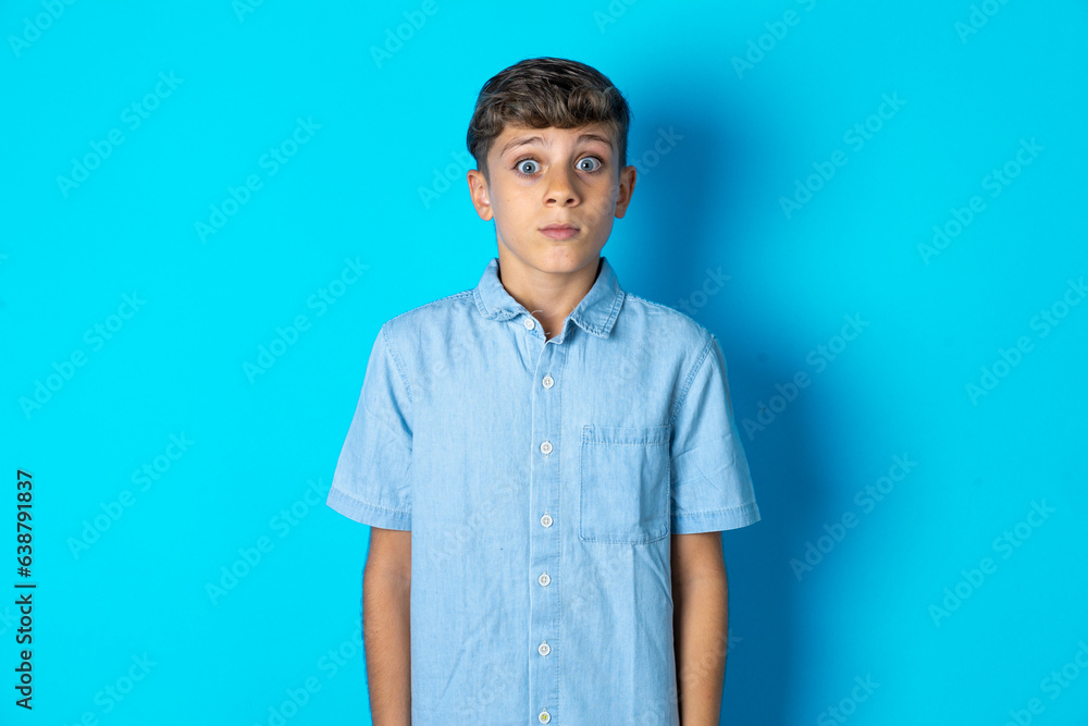 Shocked Beautiful kid boy wearing casual clothes stares bugged eyes ...