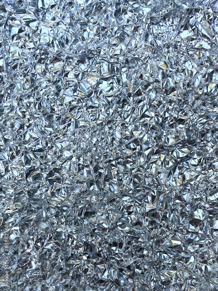 Silver metal crumpled kitchen foil sheet closeup, wrinkled grunge ...