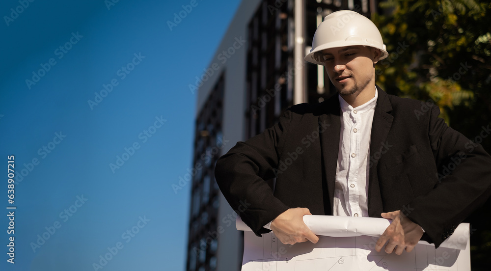 professional male engineer in special uniform and helmet holding ...