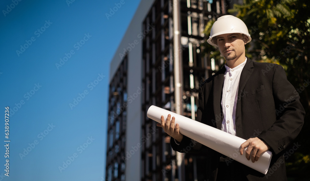 Civil engineer using a tablet, planning a project, builds a modern ...