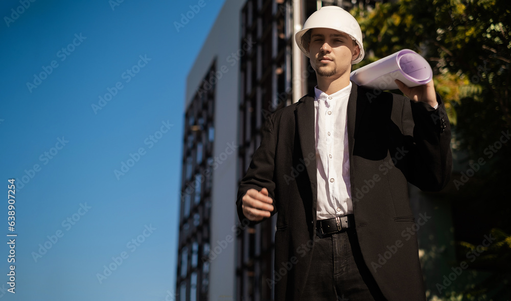 Civil engineer using a tablet, planning a project, builds a modern ...