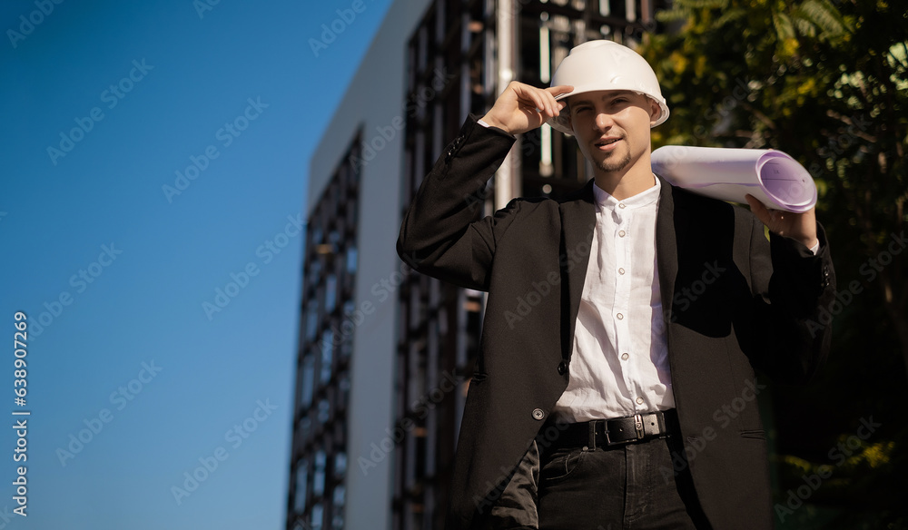 Civil engineer using a tablet, planning a project, builds a modern ...