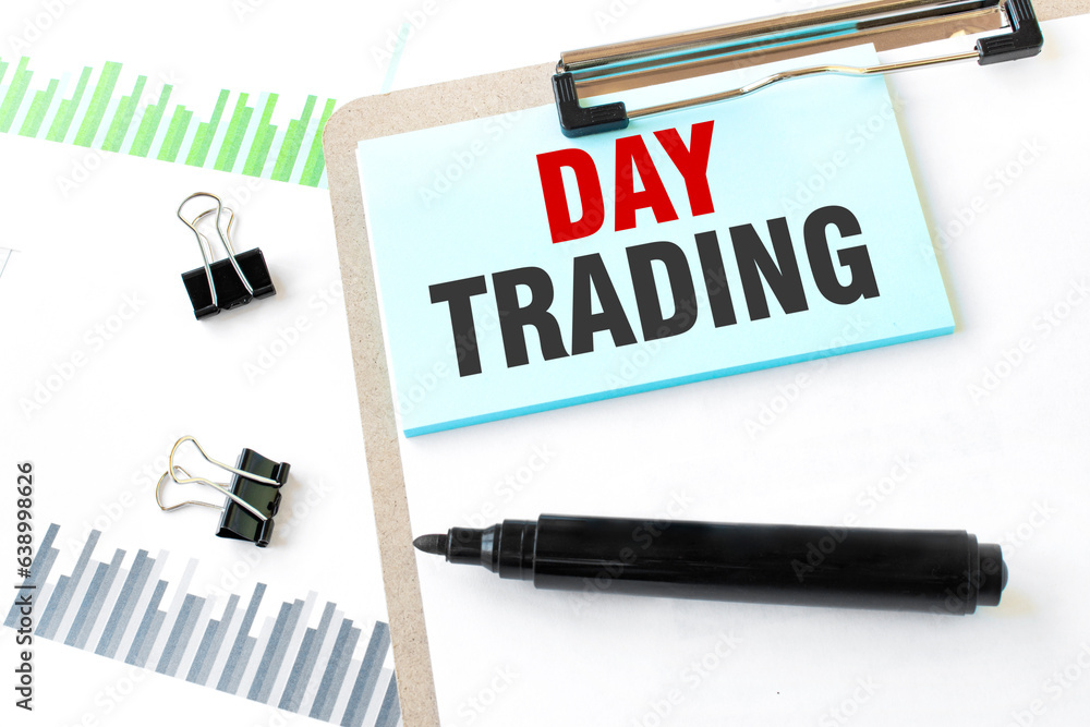 Paper plate, marker, diagram, chart and office tools. Text DAY TRADING ...
