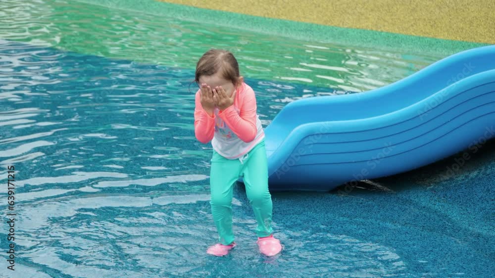 Cute Toddler Girl in Aquapark Jumps in Shallow Puddle Pool Happily Like ...