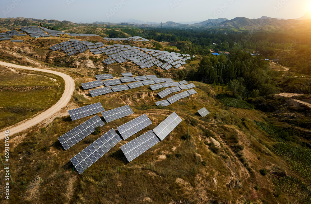 Aerial photography of solar photovoltaic cells built on a hillside ...