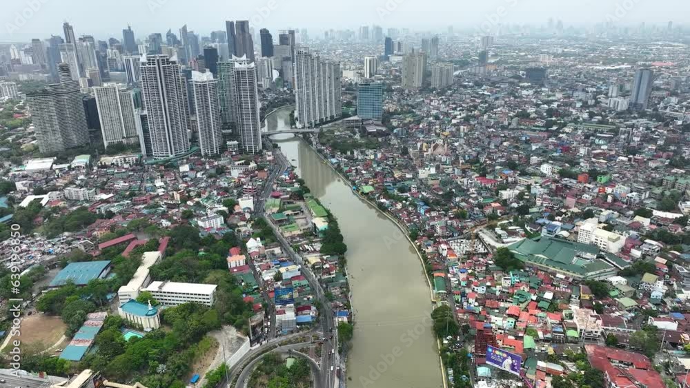 Manila cityscape at river banks aerial. Downtown area with cottages ...