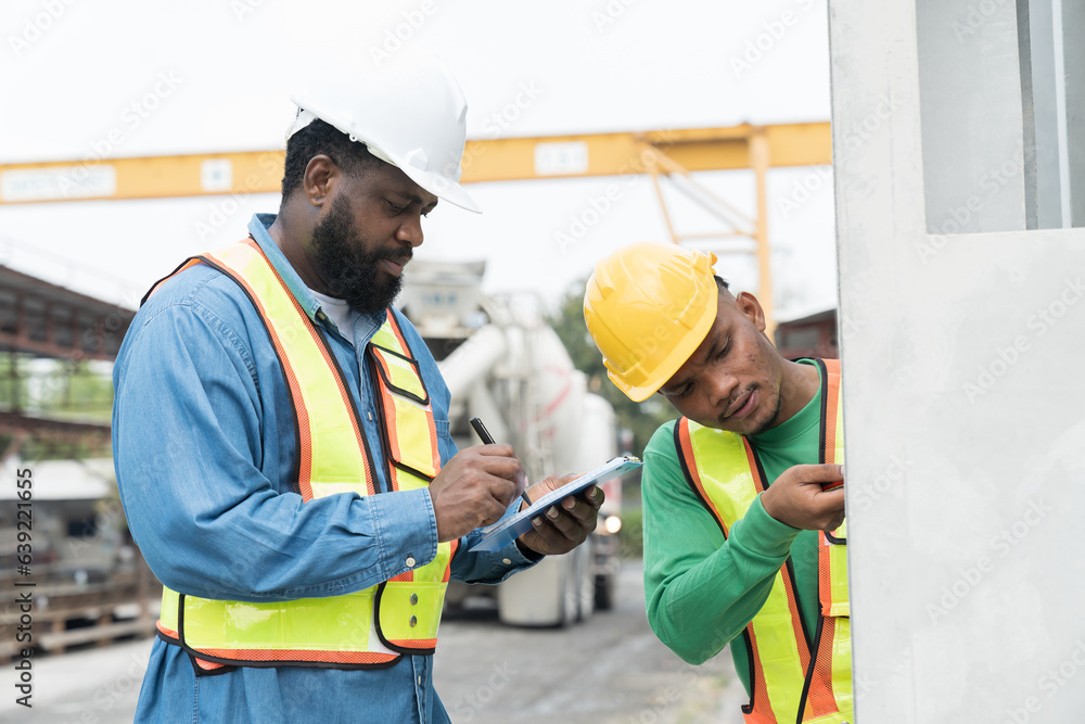 Foreman construction and male builder inspecting quality of precast ...