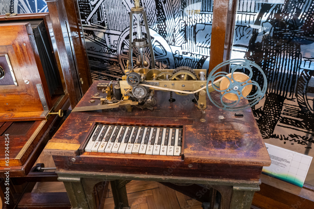 An old wooden telegraph with a keyboard and a tape. The first means of ...