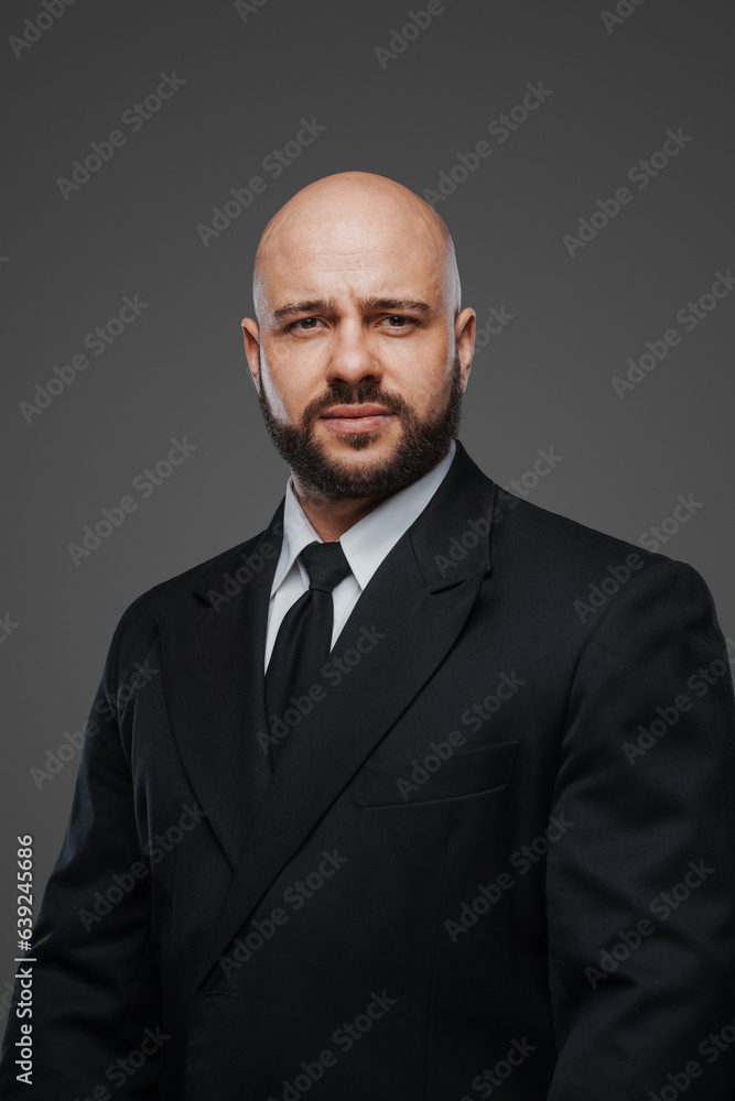 Authoritative bald gentleman with a stout build and beard, clad in ...