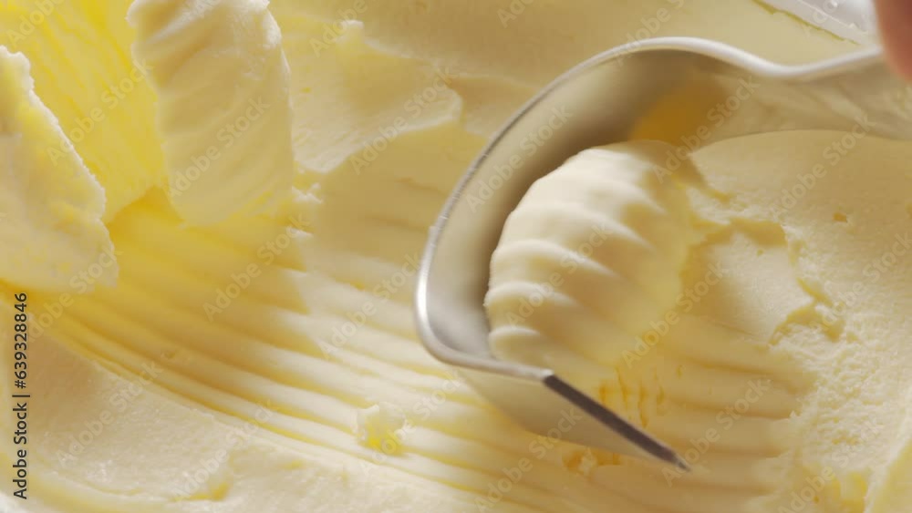 Butter is scraped off with a special butter knife from a pack of butter ...