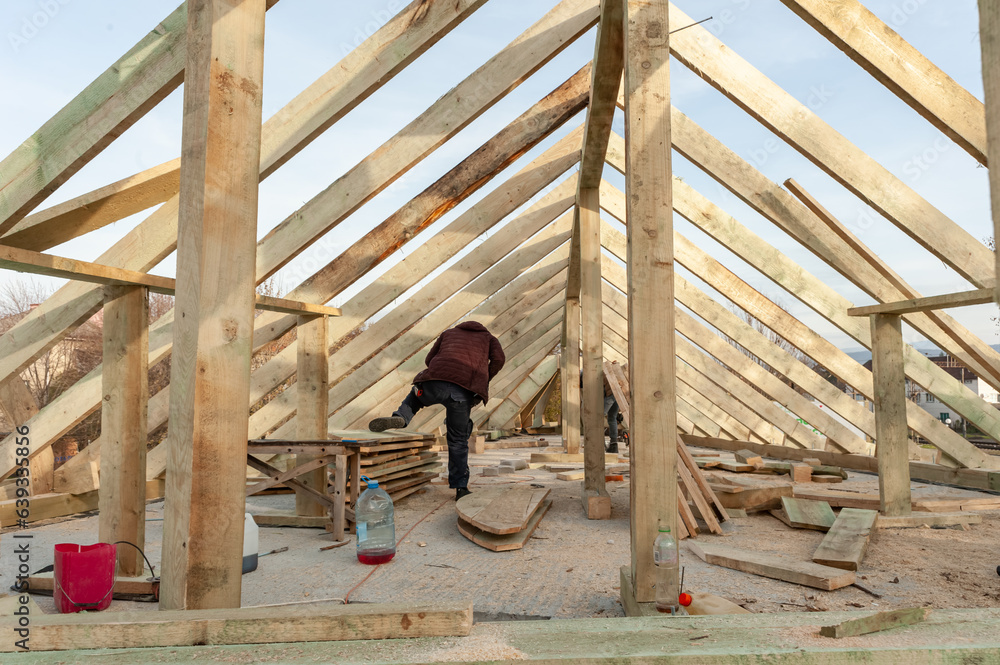 We install roof rafters on a new building. Stock Photo | Adobe Stock
