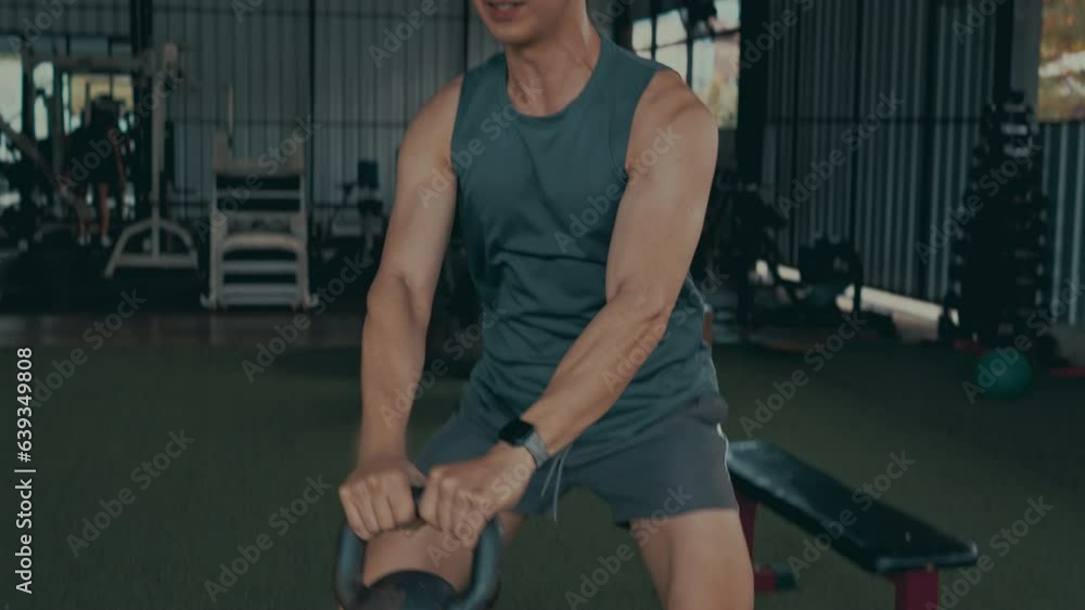 Dedicated Bodybuilder Swinging kettlebell in Intense Biceps Workout at ...