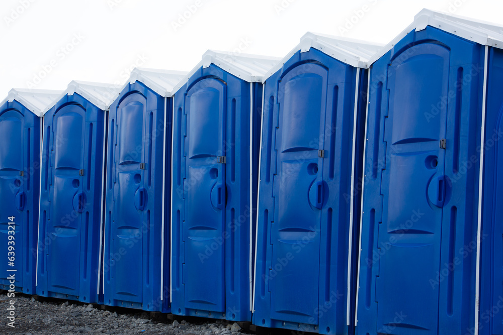 Row of blue portable chemical booths of bio toilets. Portable mobile ...
