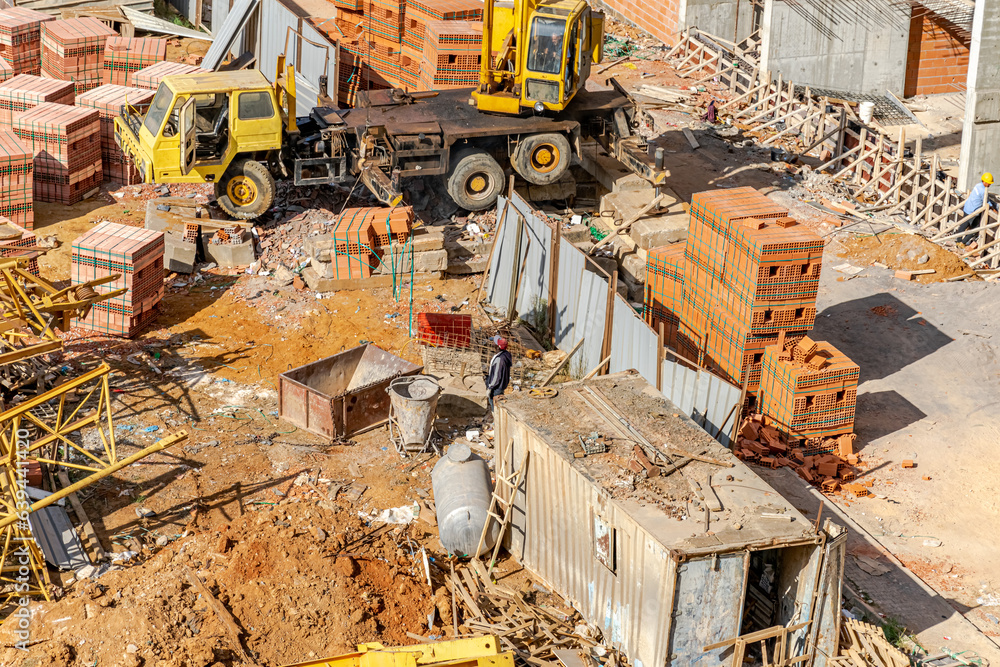 Aerial view of a messy construction site with unrecognizable people ...
