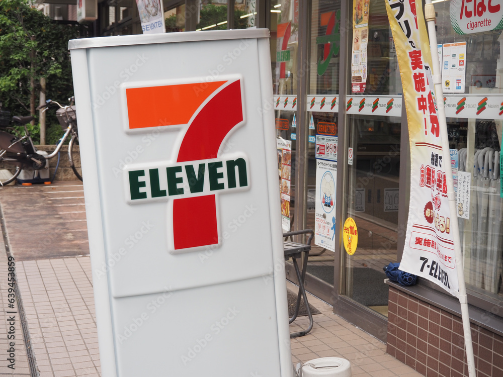 TOKYO, JAPAN - August 24, 2023: Sign at the front of a 7-Eleven convenience store in Tokyo's ...