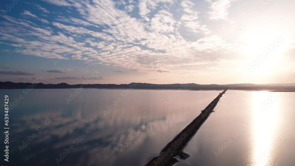 4K Aerial drone shot of infinite road and salt water lake on both sides ...