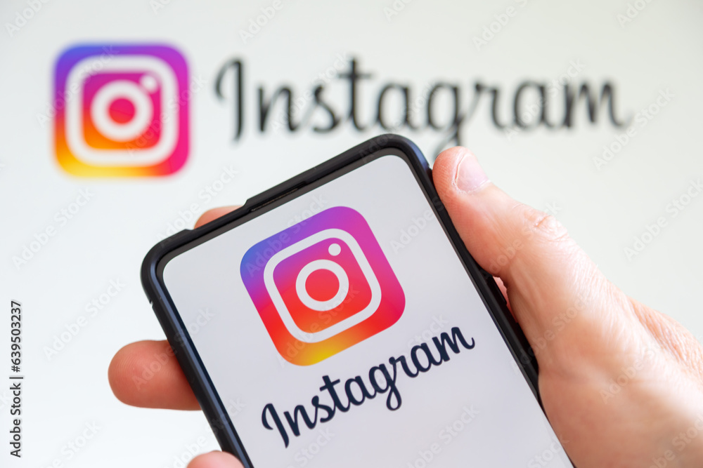 Hand holding a mobile phone with Instagram logo social media computer ...