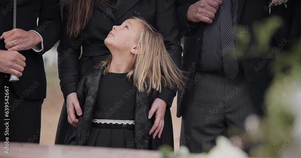 Mourning, grief and family with girl at funeral, flowers on coffin ...