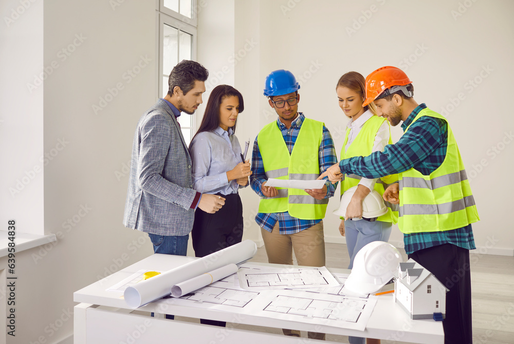 Homeowner couple discussing home renovation plan with professional ...