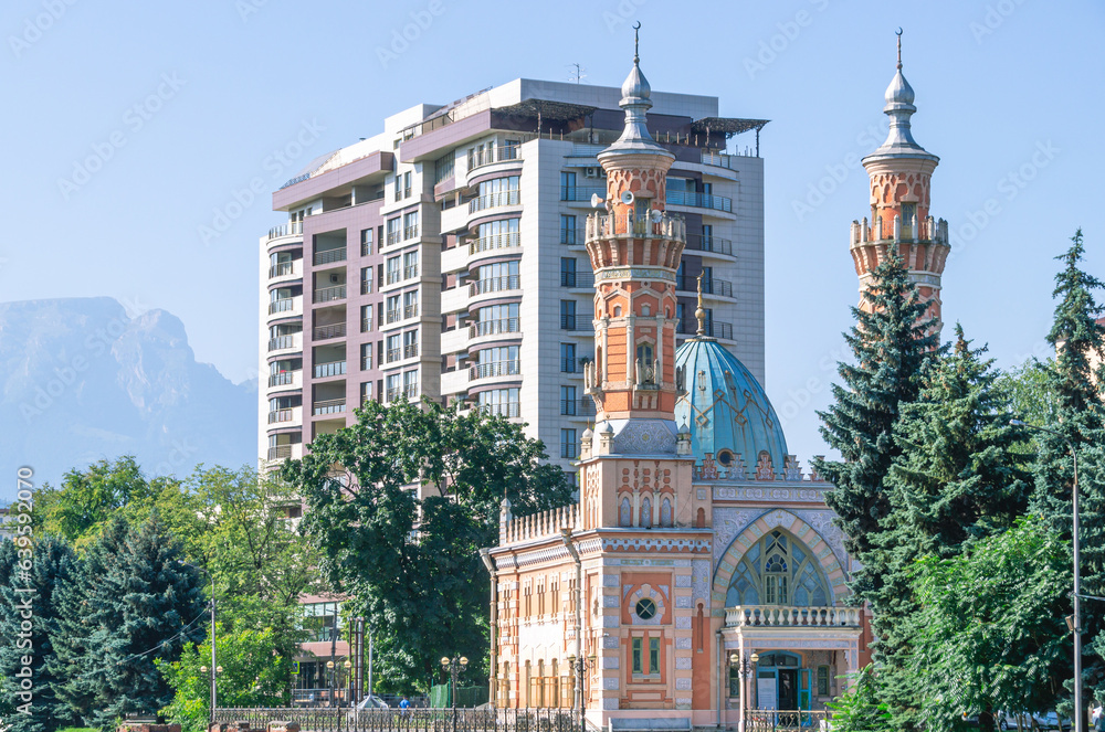 An ancient Muslim mosque with domes on the background of mountains. The ...