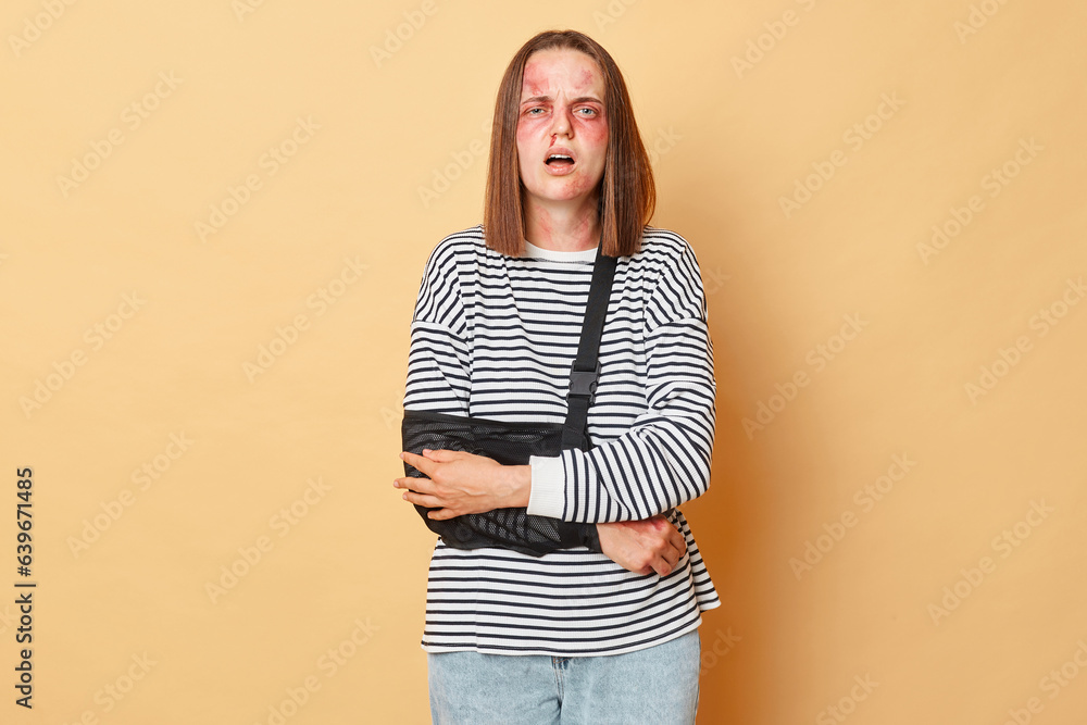 Shocked scared woman with scratches and bruises on face with bandage ...