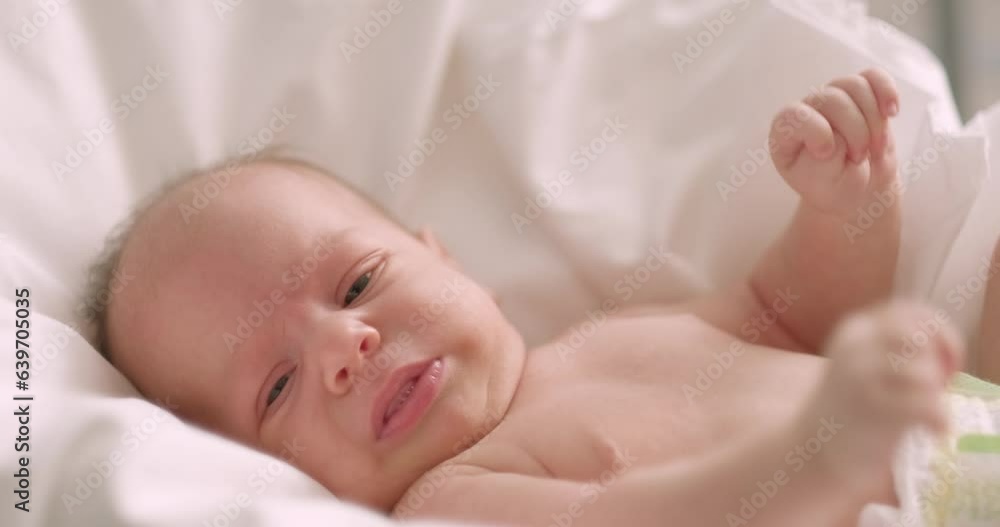 Dissatisfied, crying, upset, sad Newborn baby boy lying in nursery in ...