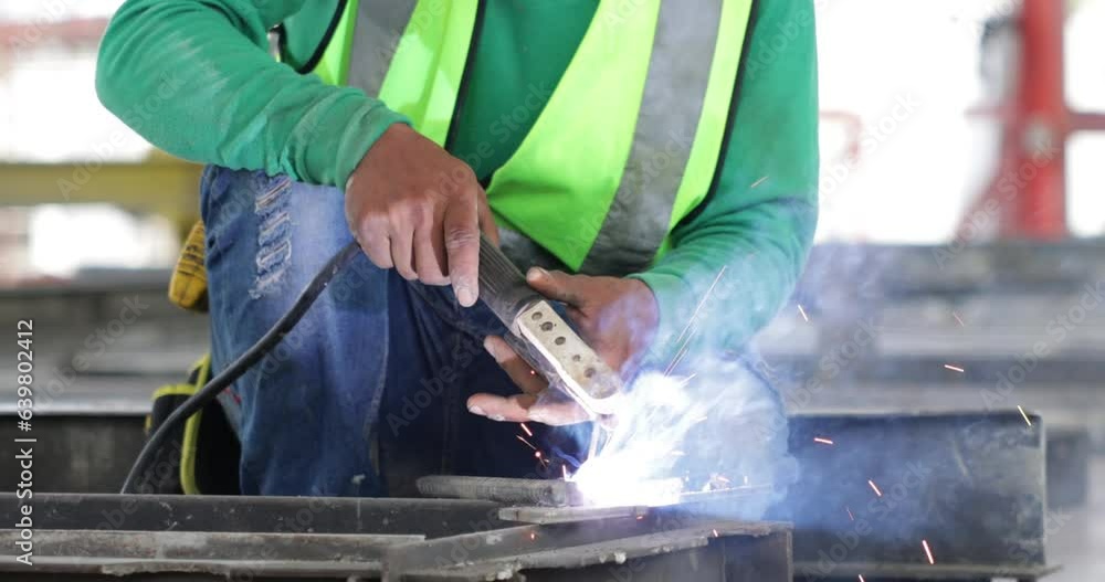 welding. Asian man worker weld metal with a arc welding machine at the ...