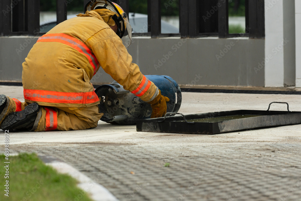 Showing how to use a fire extinguisher on a training fire for employees ...