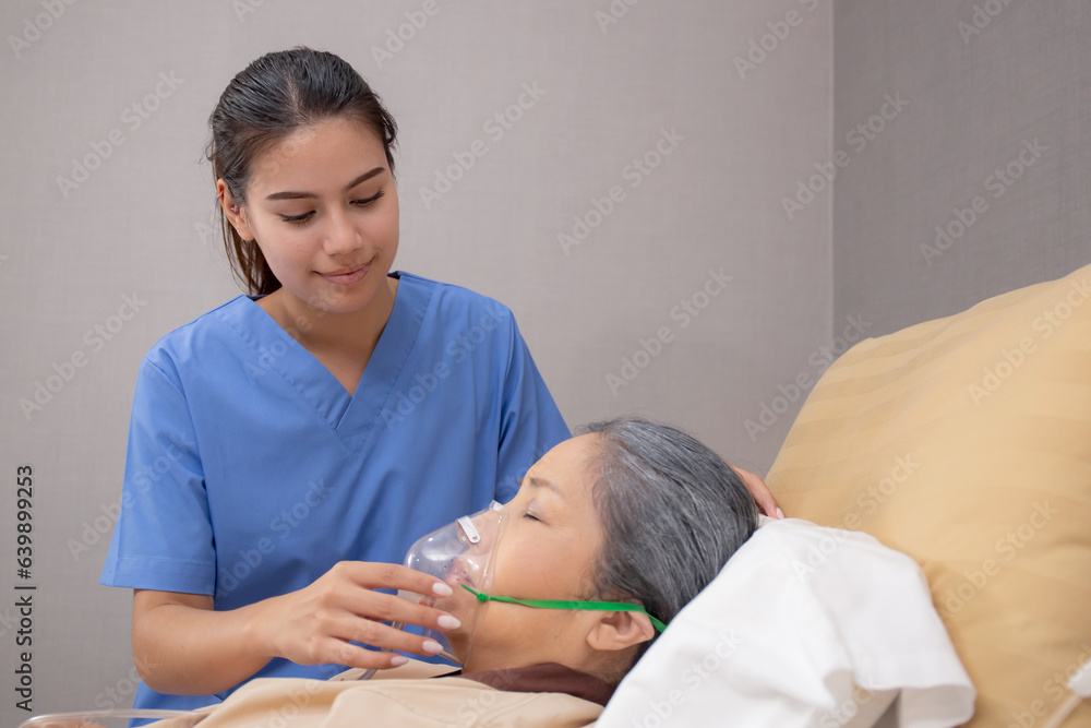 Nurse putting oxygen mask with patient elderly woman on bed for ...