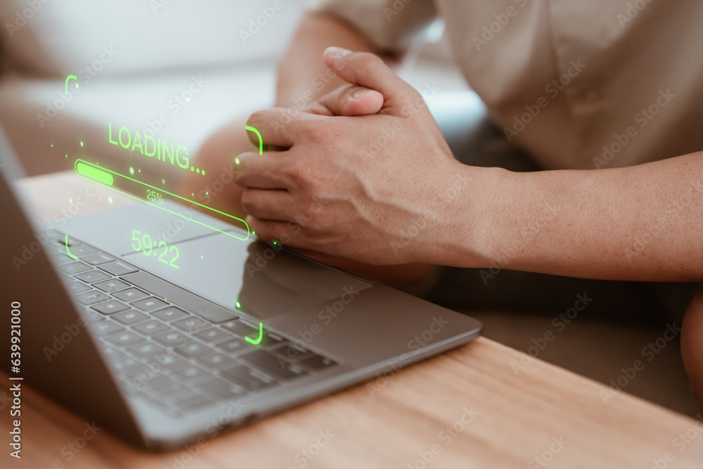 Foto de Man use a laptop computer to download and update software with ...