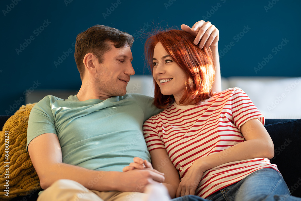 Loving married couple tender looking at each other holding hands share ...