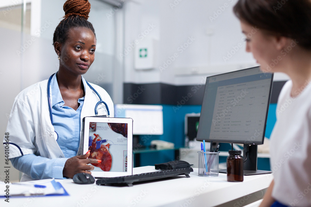 Cardiologist doctor and patient heart check-up consultation, describing ...