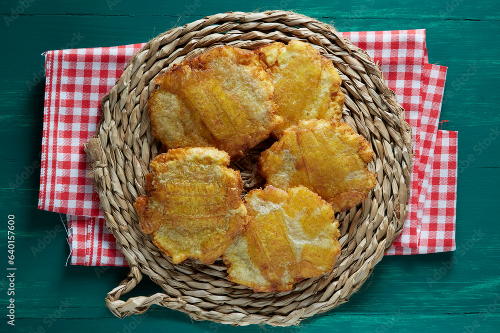 Patacones, also known as tostones, are thick pieces of fried green ...