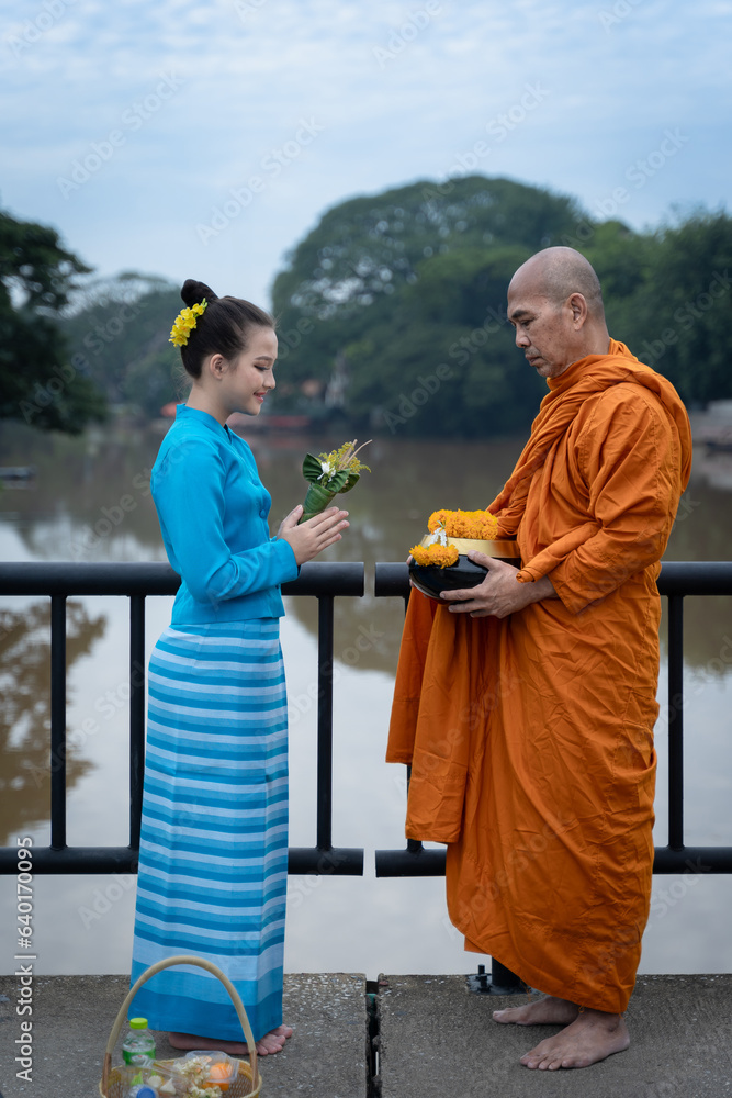 Women make merit offer food and put it in monk alms bowls with monks in rural areas according to ...