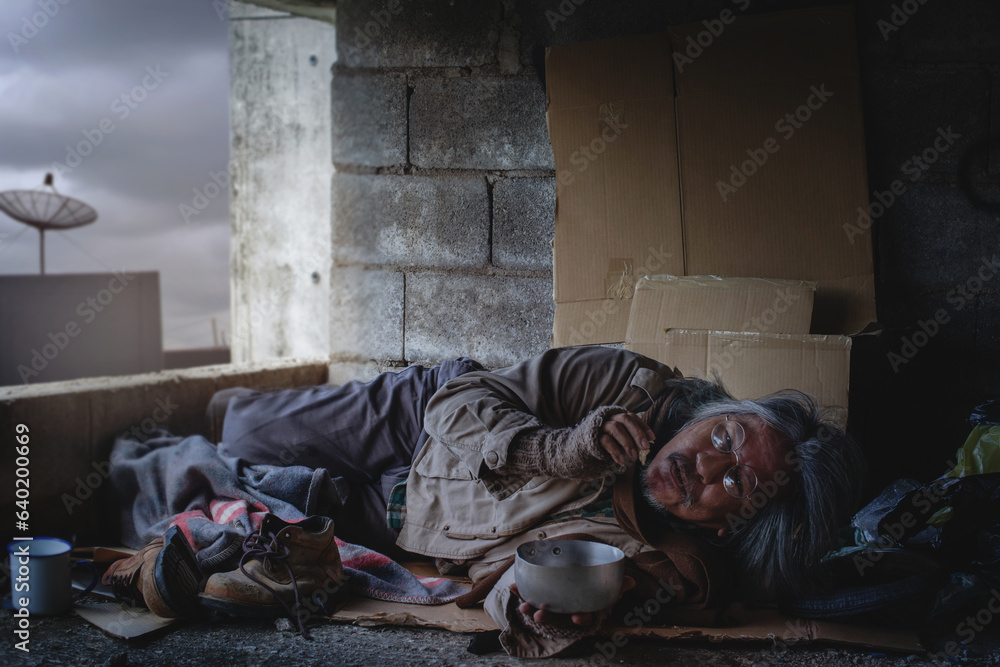Homeless old man lay in an abandoned building that was cluttered and ...