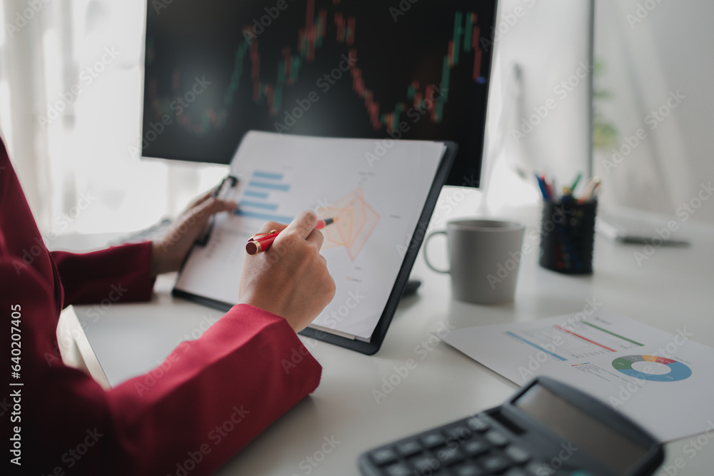 Asian woman looking at stock market graph screen, stock market ... Asian woman looking at stock market graph screen, stock market ...