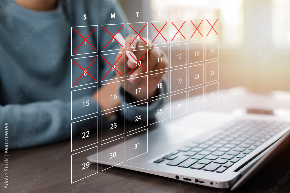 Business people use pen to write crossed-out online calendars and write ...